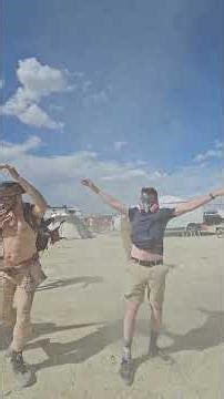 People Play Inside Small Dust Devil at Desert Camp
