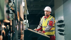 Worker manages production process using CNC machine
