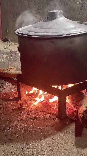 Outdoor Cooking with a Large Metal Pot over Fire