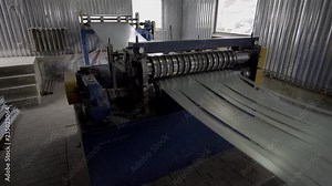 Sheet metal cutting machine for the production of steel pipes. machine for slitting steel sheet. Industrial machine for steel coils cut.