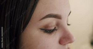 Eyebrow tinting procedure with henna in a beauty salon. Dyeing eyebrows with henna apply applying. Master in black gloves makes permanent eyebrow makeup, cosmetological procedures and beautycare.