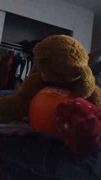 big teddy bear sitting and deflating a 44 cats hopper ball