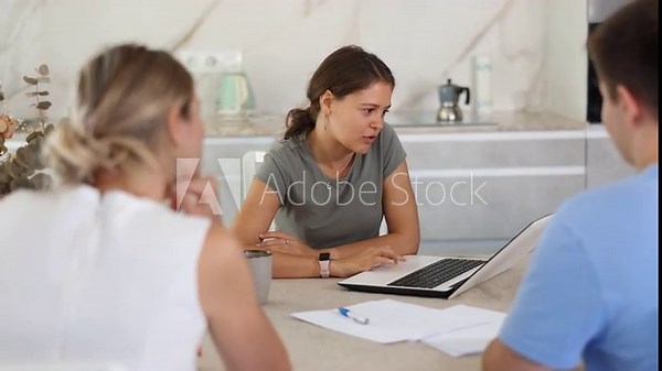 Girl manager tells clients about specifics of design of microloan, about benefits and advantages. Seller draws up contract on laptop. Affordable credit conditions, cryptocurrency transactions