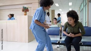 Reception area in modern hospital with patient information counter and group of professional doctors and nurses working in medical center health services. Concept of medical and wellness tourism.