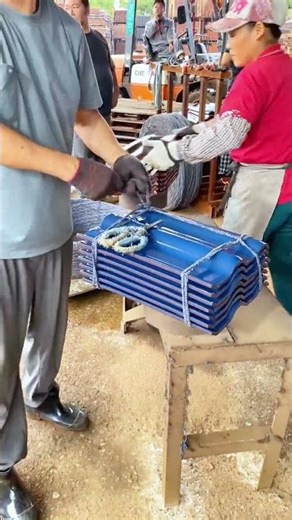 Preparing and Strapping Stacks of Blue Corrugated Roof Tiles