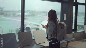 Happy asian tourist woman using mobile smartphone with backpack traveling between waits for flight in Airport Terminal, Browse Internet, flight check in, Tourist journey trip concept