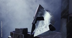 Side view of steel mask for knight, warrior protecting. Blacksmith forging armor for knight of medieval times, smoke spreading around. Concept of blacksmith art and forging.