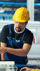 Vertical Photovoltaics factory manager delegating tasks to employee, improving solar panels efficiency. Team leader sends worker to make adjustments after researching more sustainable solar solutions, camera B