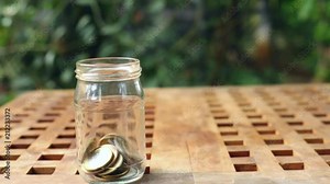 no sound stop motion video footage dropped coin Glass and growing small plant, illustration for business profit increase