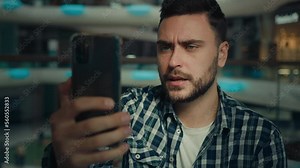 Millennial blogger caucasian hispanic man businessman business consultant speak mobile phone via digital webcam app on smartphone talk online friend business cell telecommunication use wi-fi network