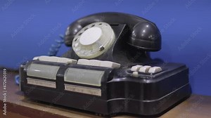 An old vintage telephone with a dial, buttons for switching and a handset from the 70s. Stock Video