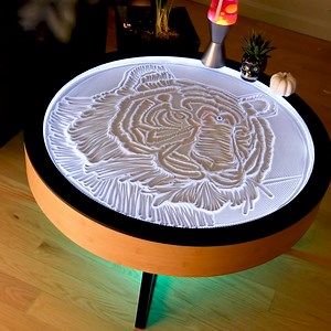 3.2K views · 13 reactions | Imagine a coffee table that’s more than just furniture – it’s a mesmerizing work of art. Our Oasis kinetic art coffee table uses a small ball controlled by a hidden magnet to create intricate sand patterns that are soothing to watch. | Grounded Labs | Facebook