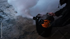 Smoke fog machine in action. The smoke machine releases a large cloud of smoke onto the stage