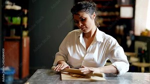 masterclass of clay modeling in art workshop, adult beautiful woman is working with piece of clay