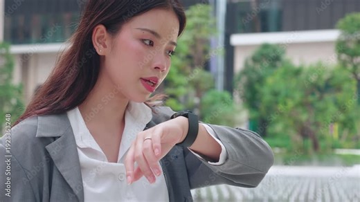 Young asian businesswoman using voice recording or speech recognition technology in smartwatch for voice command with AI, business woman talking to mic and recorder of smartwatch, virtual assistant.