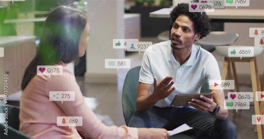 Man talking and tapping tablet, woman reading doc, social icons multiplying and showing engagement