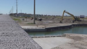 Water flows under Don Patricio Bridge, two months after its dedication