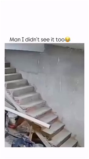 KNOWLEDGE on Instagram: "The video opens on a shot of a staircase under construction in what appears to be a basement or industrial setting. The stairs are bare concrete, and construction materials like cardboard boxes, buckets, and tubing are scattered at the base. A man wearing a dark shirt, blue shorts, and a baseball cap enters the frame, walking toward the stairs. He moves quickly, almost running up the concrete steps. As he reaches about the fifth step, his foot appears to slip or catch on