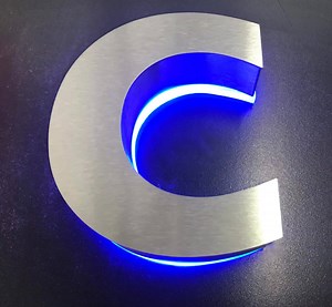 Halo illuminated stainless steel built up letter on a black background. Test sample by Roy Luther - General Manager | Impact 3D Signs Limited