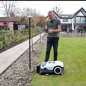 MEET THE LUCKIEST HUSBAND ALIVE! He's got a robot that mows his lawn for him! • Tap "Start" and let Genie work its magic with AI & 4-camera vision • Creates neat paths, dodges obstacles all on its own! Want to be this happy? Try Genie today! | ANTHBOT