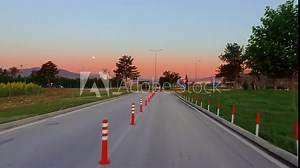 Road construction work signalization with many traffic cone signs On asphalt at sunrise, cinematic shot