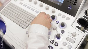 Doctor using medical ultrasound equipment, hand operating ultrasound machine