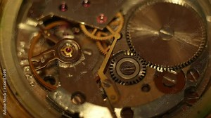 Mechanism of an old mechanical wrist watch chronometer in motion close-up. Pendulum balance wheel and running of life and time flow