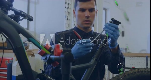 Bicycle technician adjusting hose triggers floating icons and trimming hose for suspension fit