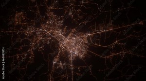 Alexandria (Louisiana, USA) top view at night. View on modern city from satellite. Camera is zooming in, rotating counterclockwise. Vertical video. The north is on the left side