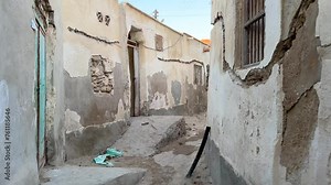 walking in desert city old town tropical climate ruins of mudbrick house Arabian culture traditional architecture design winding lane windcatcher ancient natural ventilation air flow historical house
