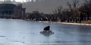 Watch: Man bikes across frozen pond in Washington, DC and it does not go well
