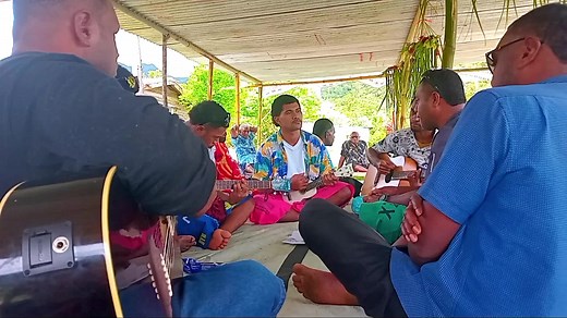 Traditional Music Gathering Under Thatched Roof