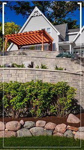 Multi-level designs transform challenging slopes into sophisticated outdoor living spaces. This ambitious hardscape project by Apple Landscaping maximizes every inch, creating distinct entertainment zones while maintaining a seamless flow throughout the landscape. 📷: #AshlarTandemWall, #BelgardOrigins, Landings Step | Belgard Outdoor Living
