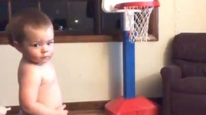 2-year-old shoots baskets behind his head without breaking eye contact