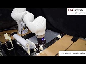 A Robotic Cell for Performing Sheet Lamination-based Additive Manufacturing