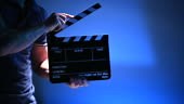 Film Production Worker with Clapperboard in Hands. Video Making...