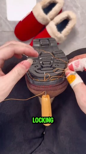 This shoemaker uses a hooked awl to punch through the rubber sole and pull the thread back, creating locking stitches that hold stronger than glue. | Lara Amélia