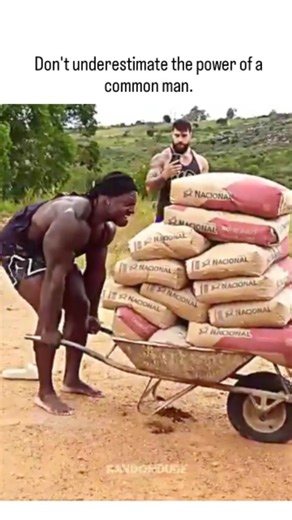 street_decode on Instagram: "The post showcases a montage video juxtaposing gym bodybuilders posing with cement bags in controlled settings against African construction workers manoeuvring multiple 50kg bags via wheelbarrows in rugged outdoor conditions, underscoring functional versus aesthetic strength. Authored by a French-born American MAGA supporter, the caption "Don't underestimate the power of a common man" taps into populist admiration for working-class grit, amassing 11,300 likes and 1.2