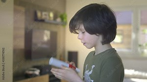 Young boy using Spirometer, Measuring Lung Capacity and Force Expiratory Volume. Close-up of boy using spirometer at home.
