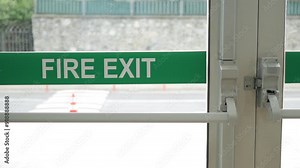 emergency exit sign on a door inside of a building