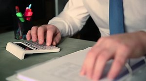 Successful business working overtime and calculating balance sheet.