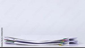 4K Footage video Stop motion of stack paper falling on white background, paperless concept in office.