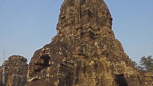 Giant stone faces at Bayon Temple at sunset, Angkor Wat, Cambodia, 4k