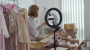 Happy Asian Mother and Baby Packing Online Orders at Home