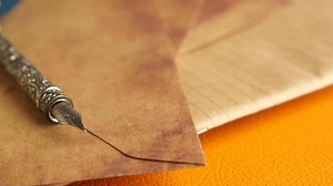 Download Writing with a fountain pen on old parchment paper for free