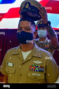 210129-N-NH199-1017  SAN DIEGO (Jan. 29, 2021) Chief Hospital Corpsman Jesse Alvarado receives his combination cover from his sponsor during a chief petty officer pinning ceremony on board Navy Medicine & Readiness Training Center San Diego (NMRTC) Jan. 29. Due to the COVID-19 pandemic, the ceremony was livestreamed via video teleconference (VTC) and Facebook Live allowing family, friends and staff to participate while adhering to social distancing guidelines set forth from the Centers for Disea