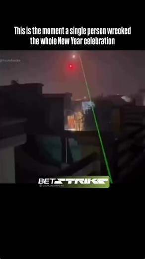 SnapFactAttack on Instagram: "New Year's Eve celebration that quickly turns from festive to frustrated. While crowds are gathered to enjoy a traditional firework display, an individual begins using a high-powered green laser pointer to interfere with the show. This act of "spoiling" the event likely refers to the safety hazards and visual disruption caused by the laser, which can be dangerous for both eyes and any low-flying aircraft, ultimately dampening the spirit of the public celebration. #N