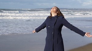 Concept of happiness and freedom woman enjoying sea light and air slow motion