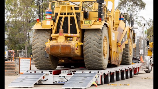 Dust. Grit. Power. 💪 Bower’s Heavy Haulage rolling out with their new Drake 7x8 Steerable, hauling a CAT 657G Scraper for Acciona — Tarantino style. Cool. Collected. Completely in control. Just pure heavy haulage cool. 🤠 #DrakeTrailers #BowersHeavyHaulage #Steerable #TheDrakeGroup | The Drake Group