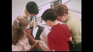 CIRCA 1960s clip of kids gathering around a Xerox copy machine and making copies.